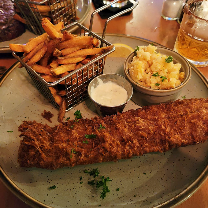 This isn't just fish and chips—it's aquatic perfection in crispy armor, served with sides that know their supporting role.