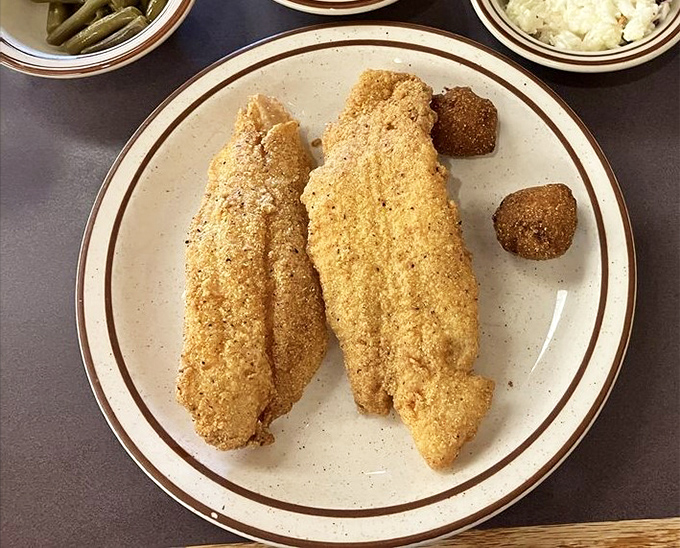 Cornmeal-crusted catfish so perfectly golden, it could make a seafood skeptic reconsider their life choices.
