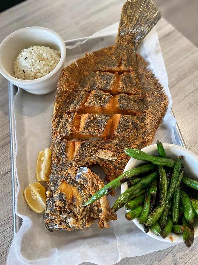 A whole fried flounder that's architectural in its presentation &ndash; crispy exterior giving way to flaky white fish that practically melts.