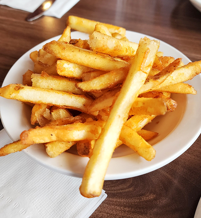 Golden fries that achieve the perfect balance between crisp exterior and fluffy interior. Potato perfection that ketchup should feel honored to meet.