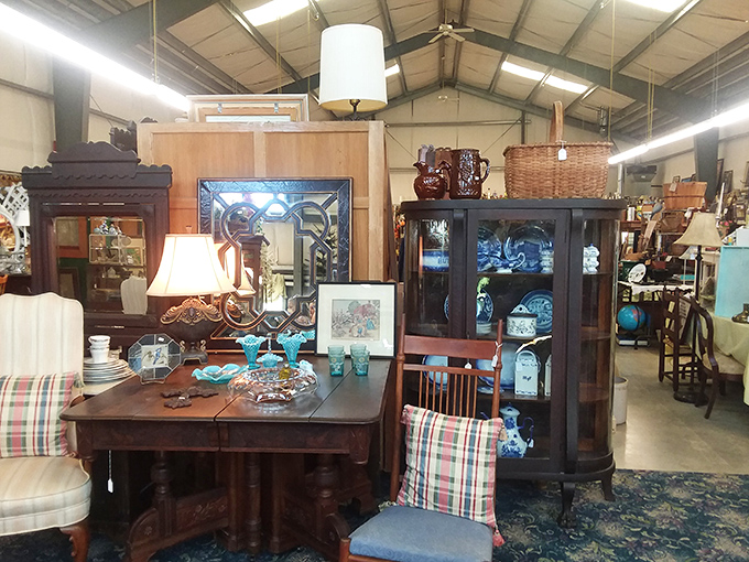 An elegant dining vignette that whispers of Sunday suppers and holiday gatherings. That curved glass cabinet has protected family heirlooms for generations.