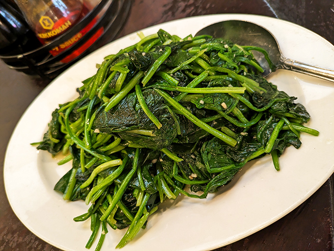 Glistening garlic spinach that might actually make Popeye weep with joy – proof that vegetables can be the main event.