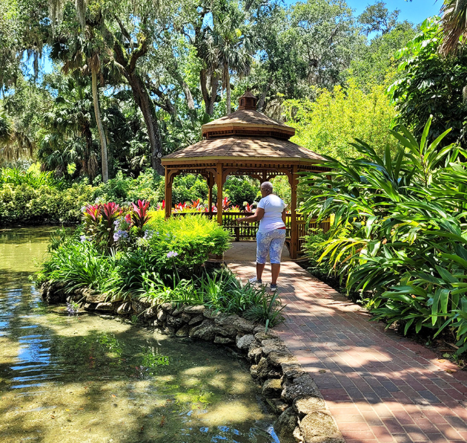 Sunlight dapples the path to this gazebo, where countless marriage proposals have likely stuttered into existence.