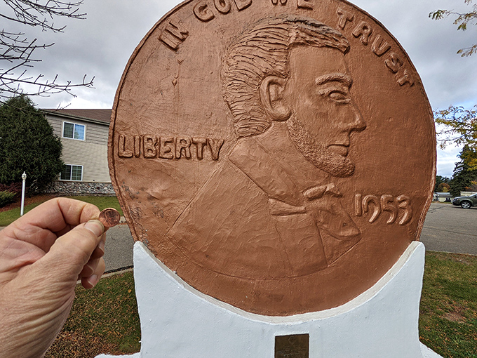 Talk about perspective! A regular penny looks positively microscopic when held up to its supersized Woodruff cousin.