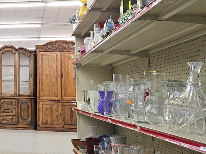 Crystal glassware gleams under fluorescent lights, ready to elevate your dinner parties from "paper cups" to "fancy adult with matching sets."