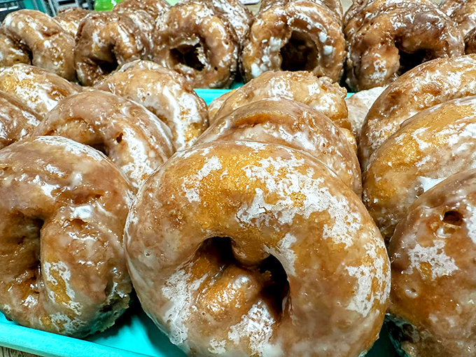 Glazed donuts lined up like golden halos, each one a testament to the ancient art of frying dough and making people unreasonably happy.