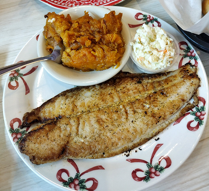 The holy trinity of Southern fish dinners: perfectly grilled whitefish, sweet potato casserole, and coleslaw. Notice how the festive plate adds holiday cheer to everyday dining.