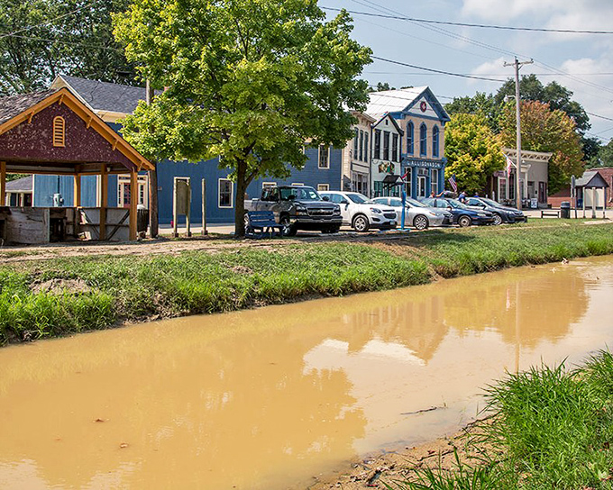 Metamora's historic buildings reflect in the canal waters like memories rippling through time. Even the cars look like they're just visiting from another century.