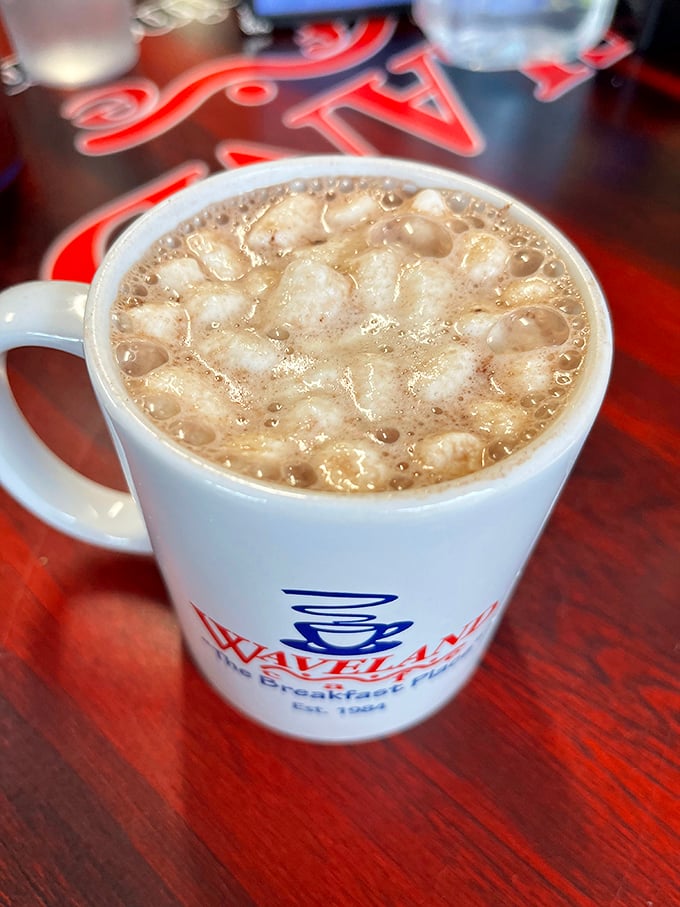 Steam rises from a mug of hot chocolate so thick it's practically pudding. The Waveland logo peeks through&mdash;a promise of comfort in ceramic form.