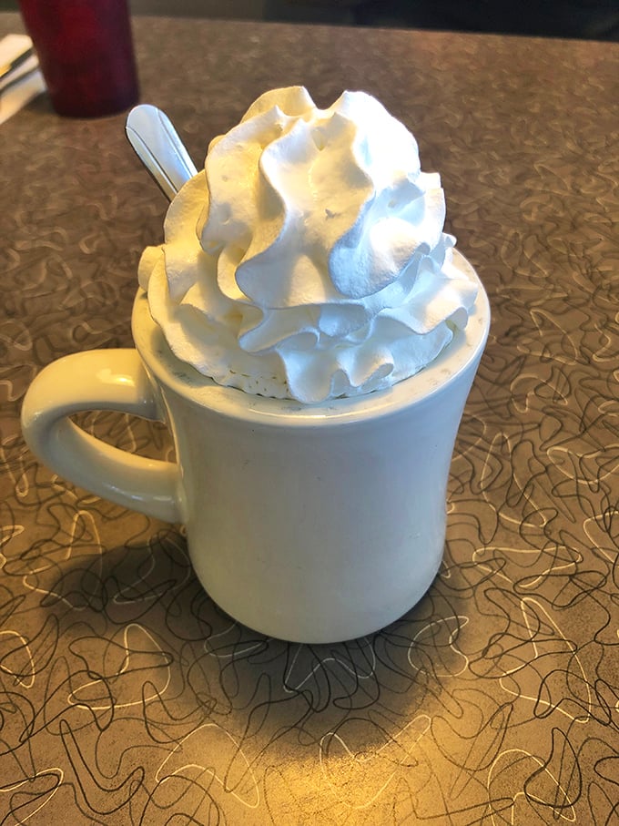 Hot chocolate that wears its whipped cream crown like royalty. Not a beverage&mdash;a warm hug in ceramic form.