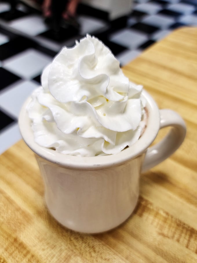 This isn't just hot chocolate&mdash;it's a warm hug in a mug, topped with a cloud of whipped cream that defies both gravity and restraint.