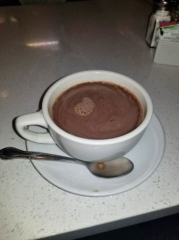 Hot chocolate so rich it should come with its own tax bracket, served in a cup that feels like a warm handshake.