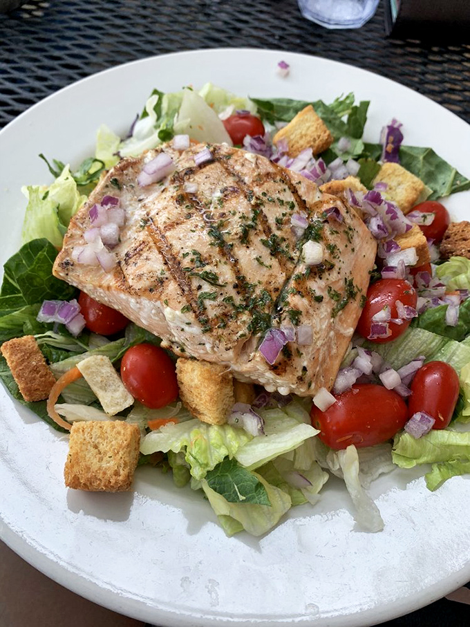A salad that doesn't feel like punishment. Perfectly grilled salmon atop fresh greens proves healthy eating can be genuinely delicious.