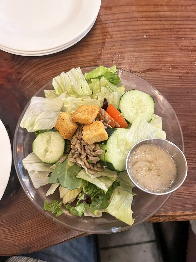 A simple house salad that knows exactly what it is&mdash;fresh, unpretentious, and precisely what your conscience ordered after eyeing that dessert menu.