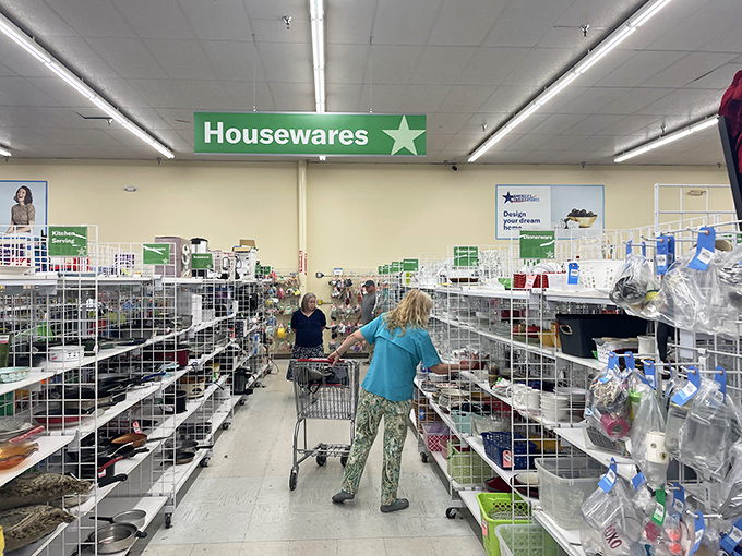 The Housewares section is where kitchen dreams come true. Shoppers navigate carts through aisles of potential place settings and cooking tools.