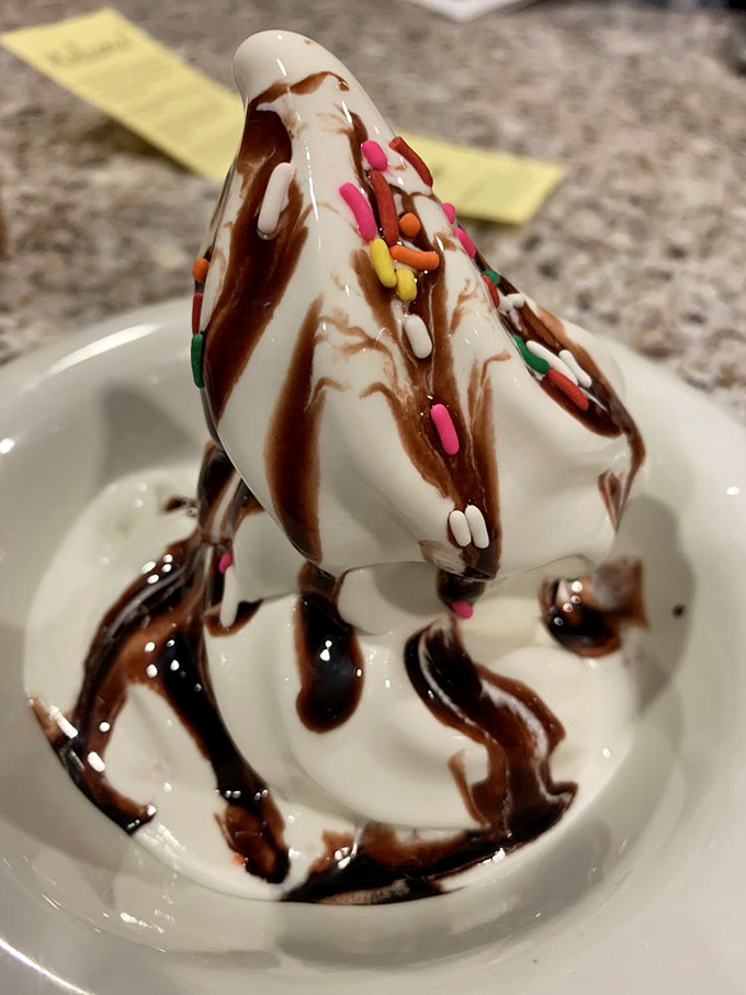 Soft-serve ice cream tower drizzled with chocolate and sprinkles &ndash; childhood nostalgia served at adult height with no one to tell you "that's enough."