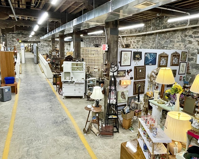Stone walls and concrete floors provide the perfect industrial backdrop for furniture displays that span decades of American home life.