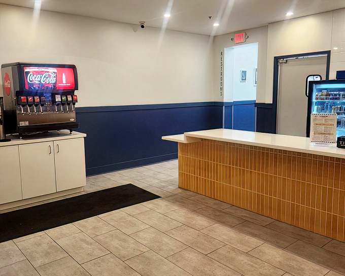 The soda machine stands ready while the counter awaits your order. In this temple of fried goodness, decisions are sacred and anticipation is half the fun.