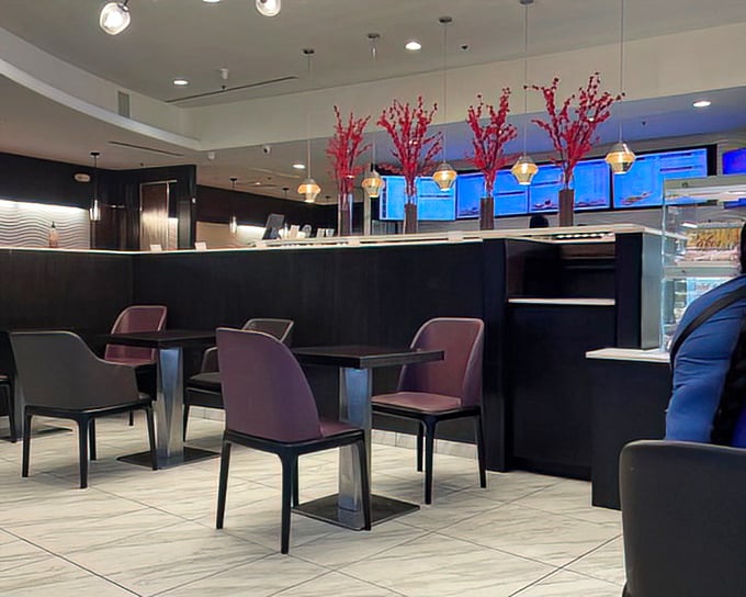 Modern minimalism meets comfort in Sweet Hut's dining area, where purple chairs invite you to settle in for a feast.