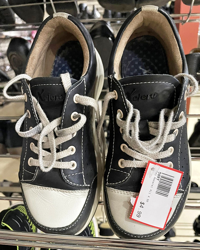 Little shoes with big potential. These navy and white kicks still have their price tag—someone's first steps waiting to happen.