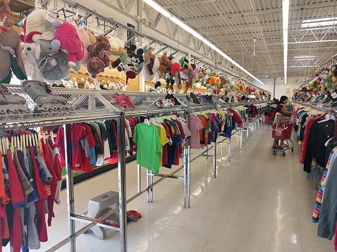 The children's section: a rainbow of tiny garments topped with stuffed animals keeping watch from above. Growing kids and shrinking budgets find perfect harmony here.