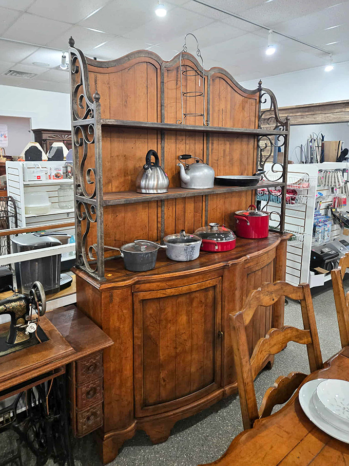 A hutch that's seen more meals than a diner waitress, now waiting for its next family to fill it with memories and mismatched dishes.