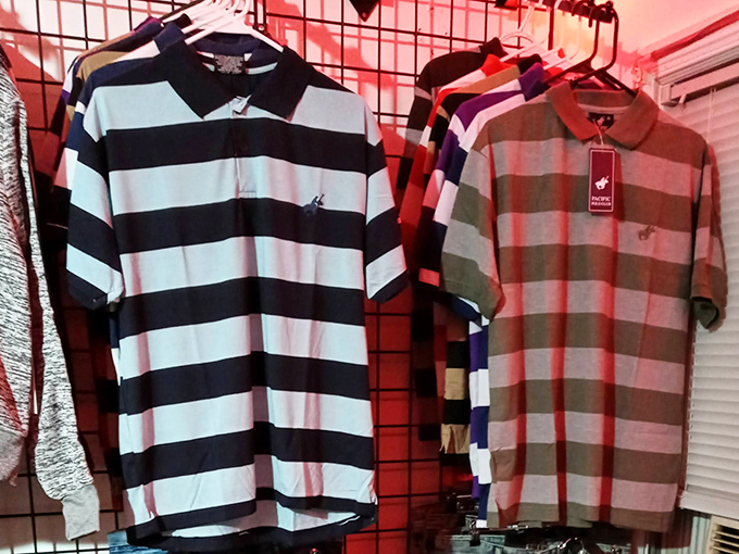 Polo shirts lined up like soldiers ready for inspection. That black and white striped number is practically begging for a golf course comeback.