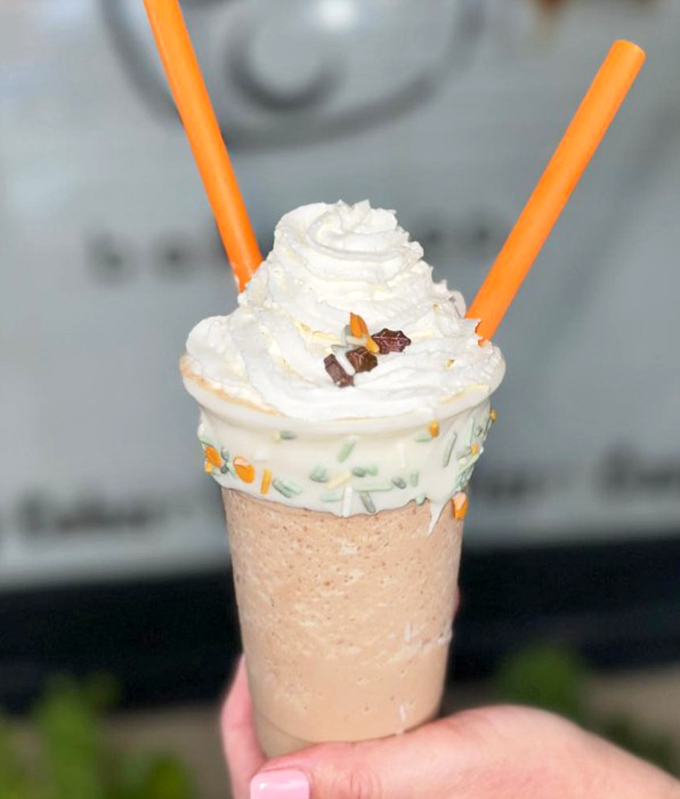 A milkshake topped with enough whipped cream to make you wonder if there's actually any milkshake underneath. (Spoiler: there is!)