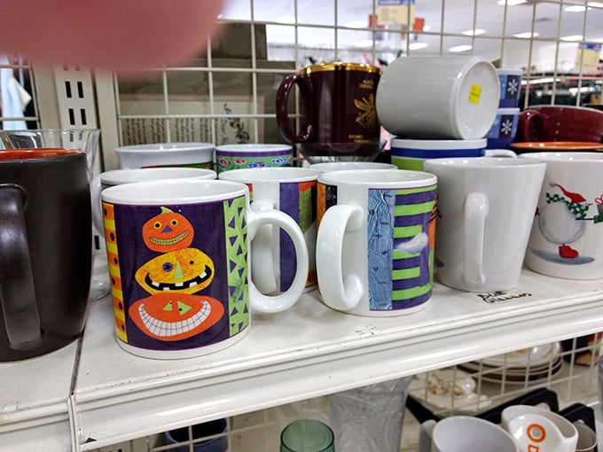 Mug museum featuring Halloween pumpkins grinning from ceramic perches. Your morning coffee deserves more personality than standard store-bought blandness.