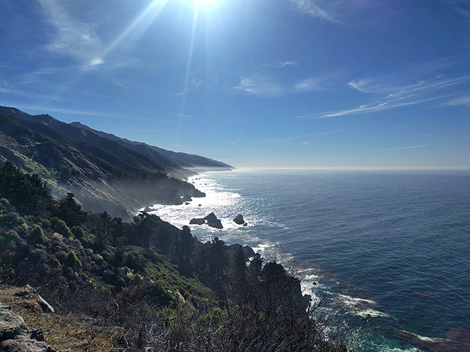 The Pacific stretches to infinity, reminding us why they named it after peace. On clear days, the horizon line seems to curve with the earth itself.