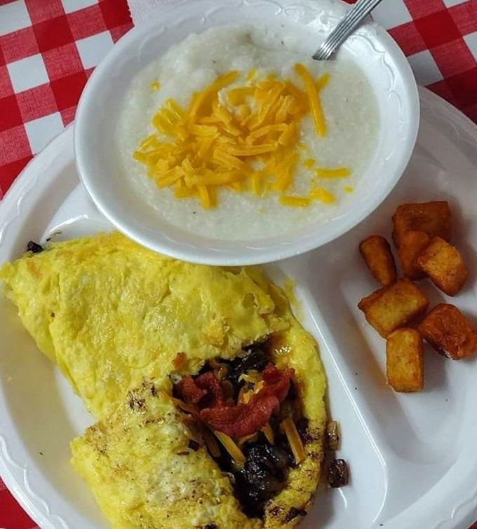 Breakfast perfection on a plate&mdash;a fluffy omelet alongside creamy cheese grits proves Southern mornings start with serious sustenance.