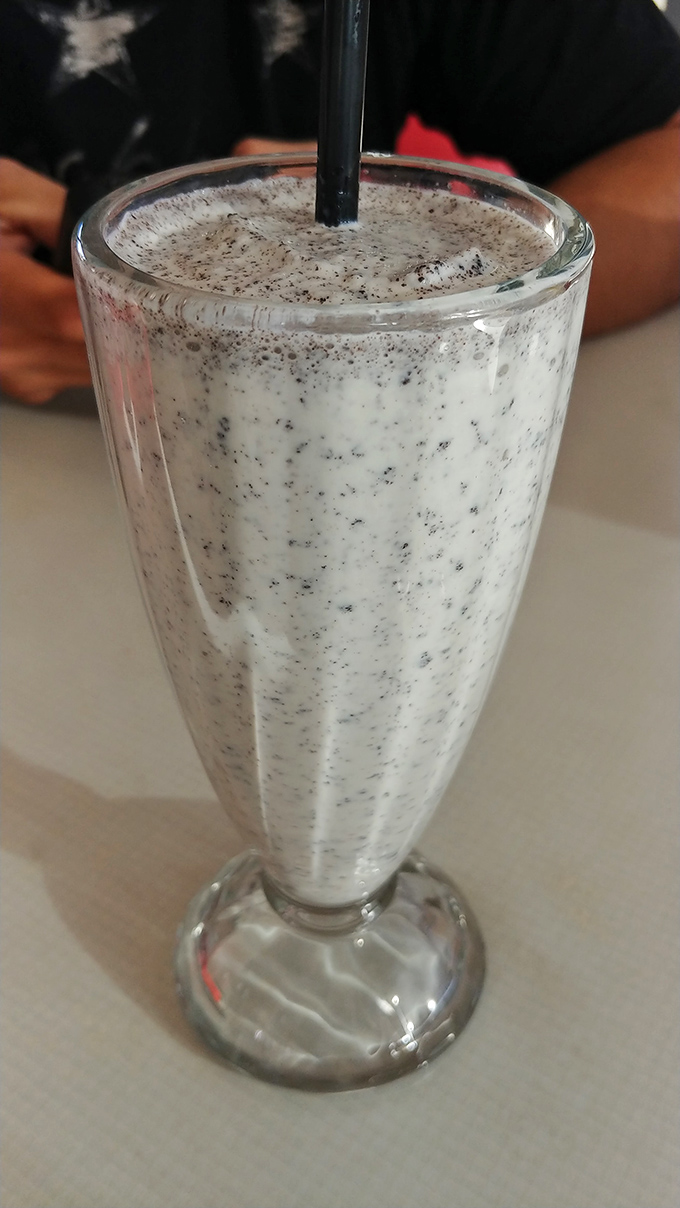 That cookies-and-cream milkshake is so thick, your straw stands at attention—a dairy delight that demands both patience and appreciation.