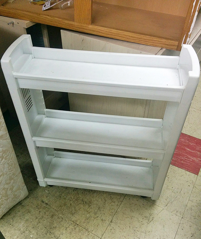 This innocent white bookshelf once organized a child's treasures. Now it waits in retail limbo, dreaming of holding plants, books, or bathroom supplies.