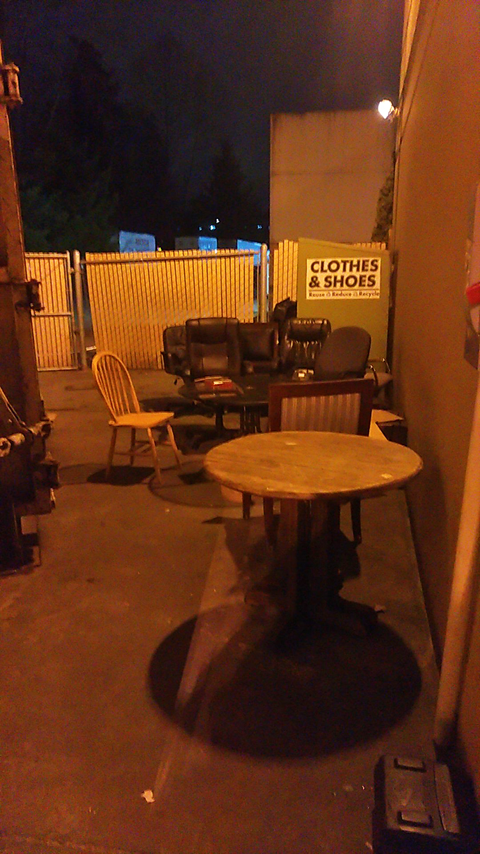 After hours, the donation area transforms into an impromptu furniture gallery where tomorrow's vintage finds await their new homes.