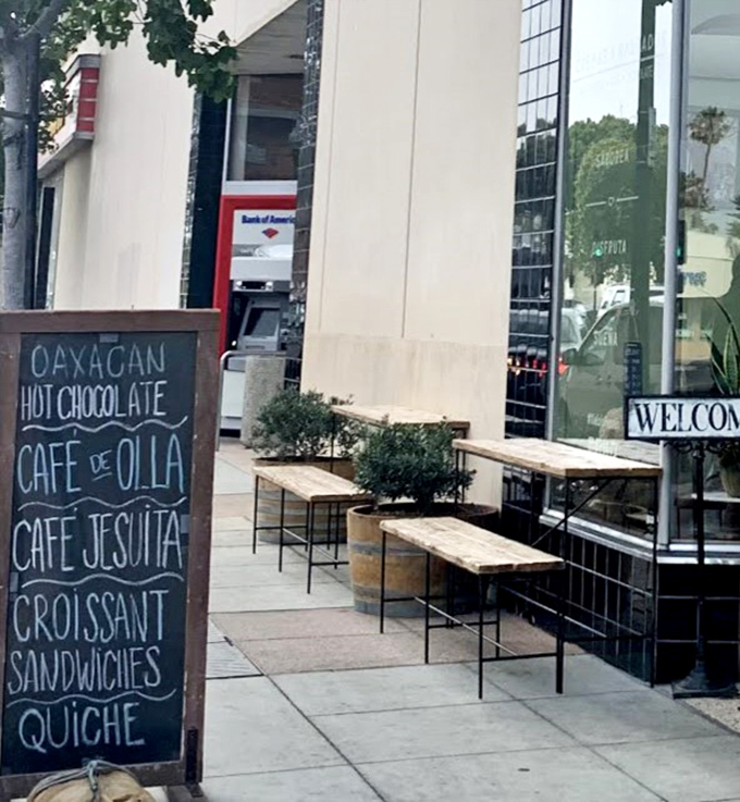 Sidewalk seating that invites you to linger like it's Paris, not Oxnard. That chalkboard menu is basically a roadmap to happiness.