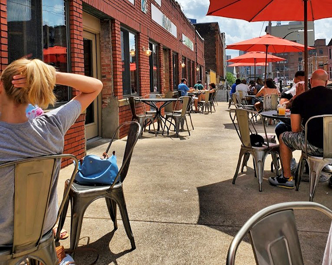 The outdoor seating area transforms Pittsburgh's Strip District into a makeshift coastal retreat, minus the seagulls eyeing your lunch.