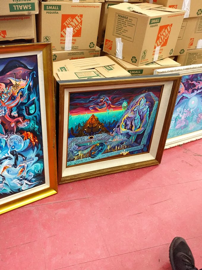 Psychedelic dreamscapes and vibrant artwork leaning against storage boxes—the kind of paintings that make you wonder what fascinating story led them here.