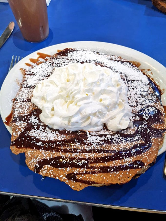 This pancake isn't just breakfast&mdash;it's dessert masquerading as a morning meal. That whipped cream mountain could have its own zip code.