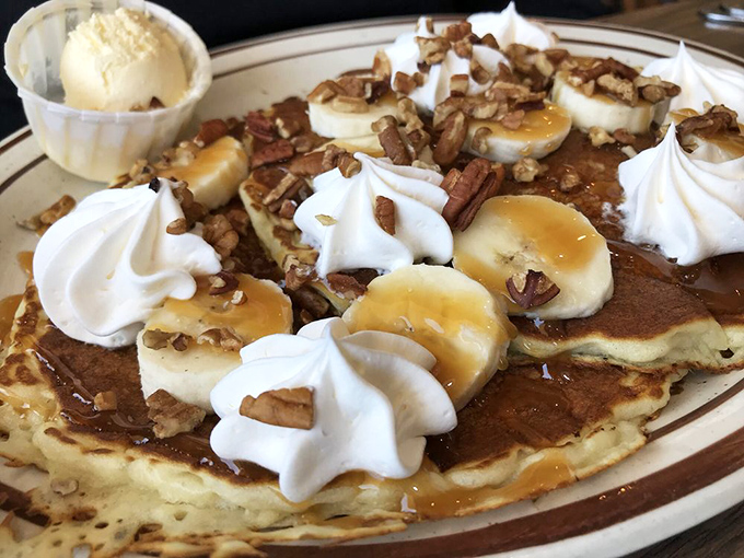 These pancakes topped with bananas, pecans, and whipped cream could make a nutritionist weep, but in the best way.