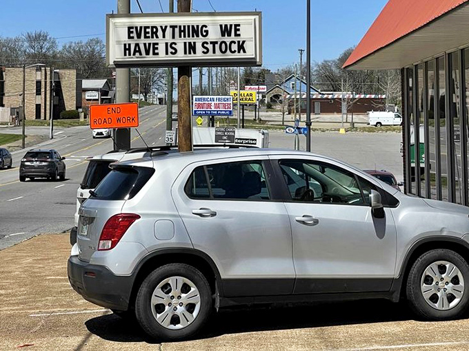 The parking lot – first stop on your journey to yesteryear. That "END ROAD WORK" sign is oddly appropriate for a place where time stands still.