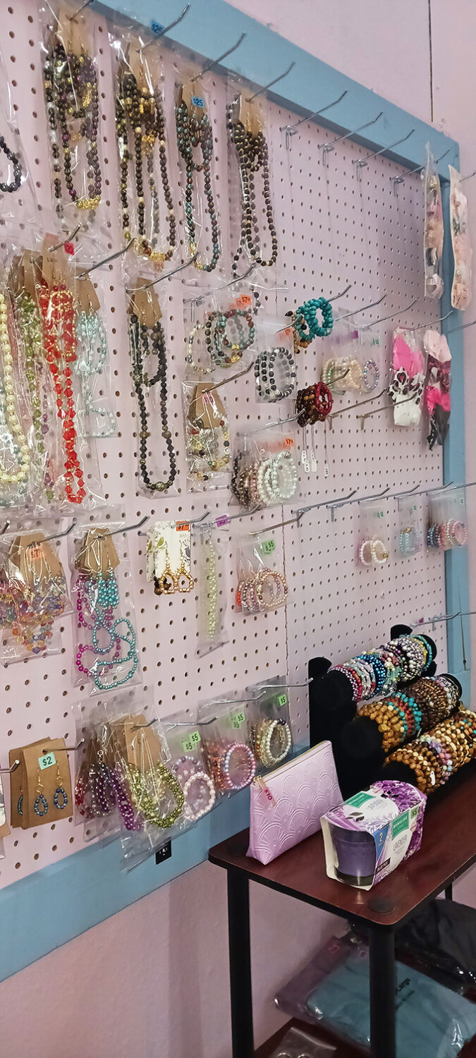 A pegboard paradise of costume jewelry where necklaces, bracelets, and earrings dangle like colorful fishing lures, waiting to catch a fashionista's eye.