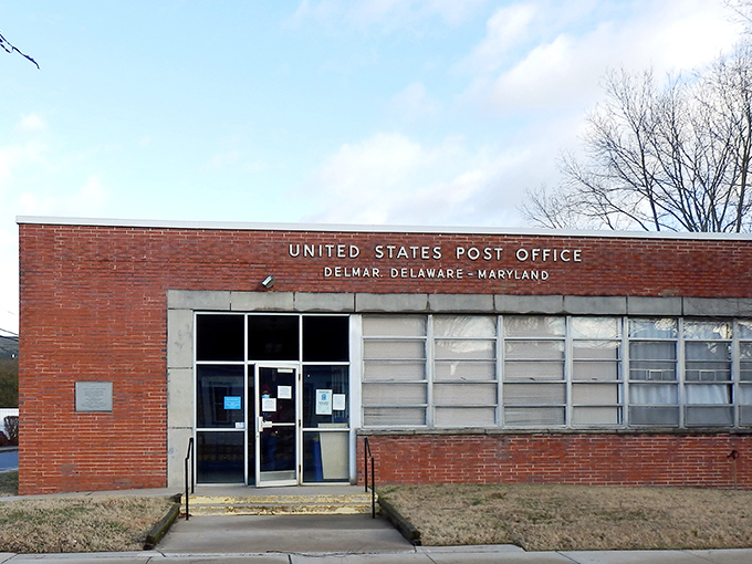 The post office proudly declares its dual-state allegiance, serving residents from both Maryland and Delaware with equal amounts of junk mail.