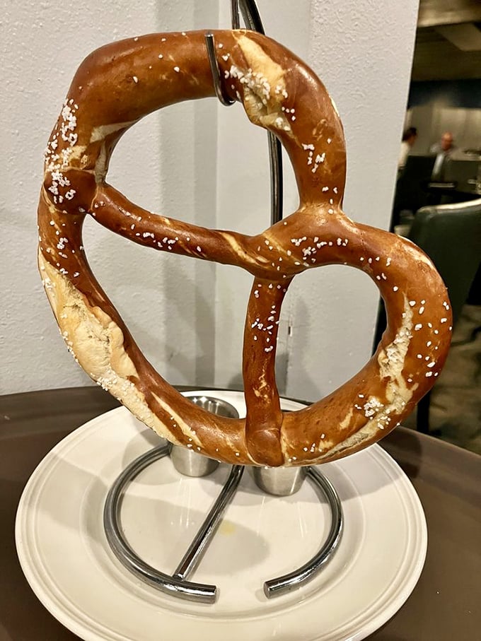 This pretzel isn't just a snack&mdash;it's architectural genius hanging from its own display stand, demanding to be photographed before devoured.