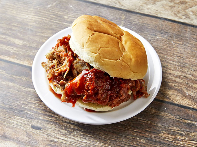 A pulled pork sandwich that requires both hands, several napkins, and a moment of silent appreciation before the first magnificent bite.