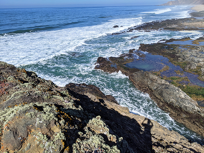 The meeting place of land and sea—where waves have been patiently sculpting this rocky masterpiece since before humans invented the selfie.