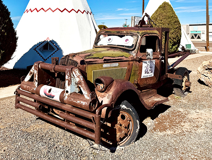 Someone gave this rusty tow truck cartoon eyes, turning Route 66 decay into Pixar-worthy charm between the teepees.