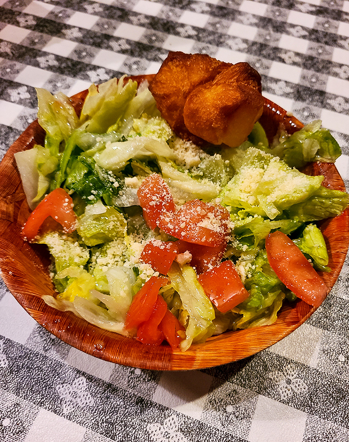 Even the salad looks like it's having a good time, dressed up with enough fresh veggies to momentarily distract you from the steaks.