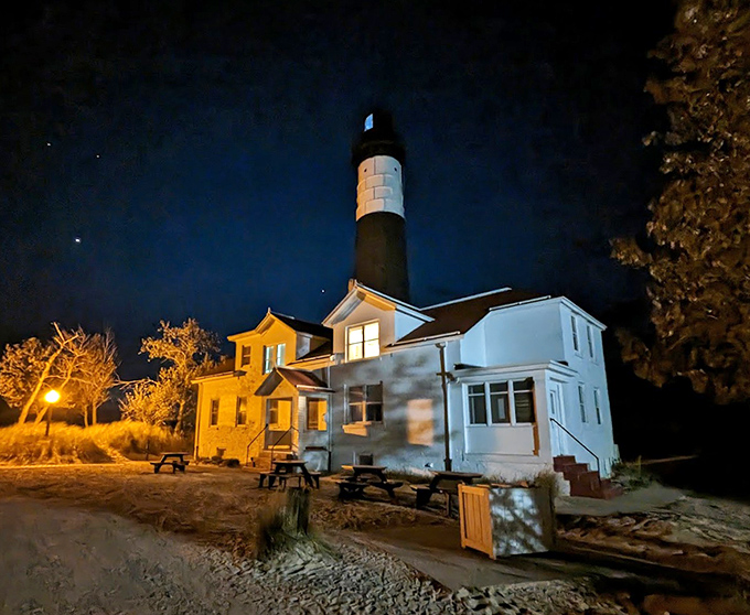 After dark, the lighthouse transforms from tourist attraction to working maritime safety equipment. Those windows glowing with warmth tell stories centuries old.