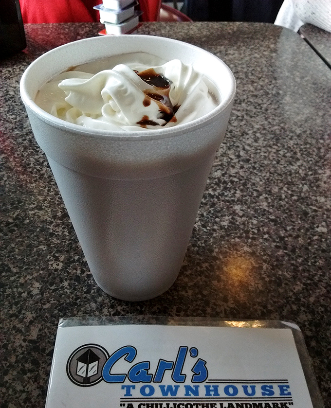 A milkshake so thick it demands contemplation between sips, served with that little paper Carl's reminder.