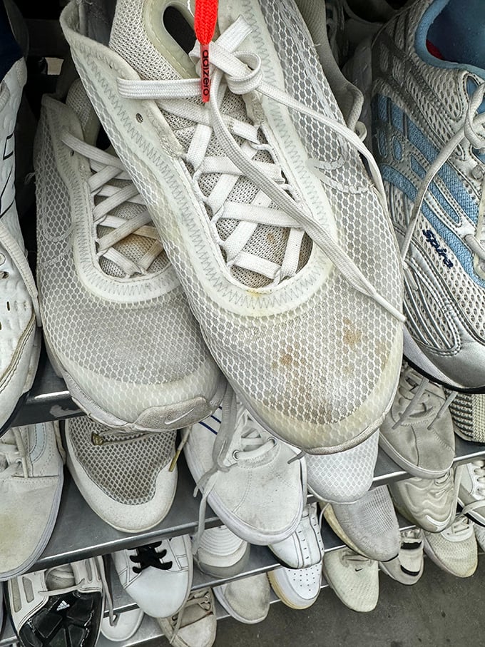 White athletic shoes stand at attention like an army of comfortable possibilities&mdash;previously loved soles waiting for new adventures.